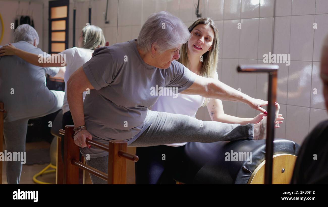 Female pilates coach guiding senior hi-res stock photography and images ...