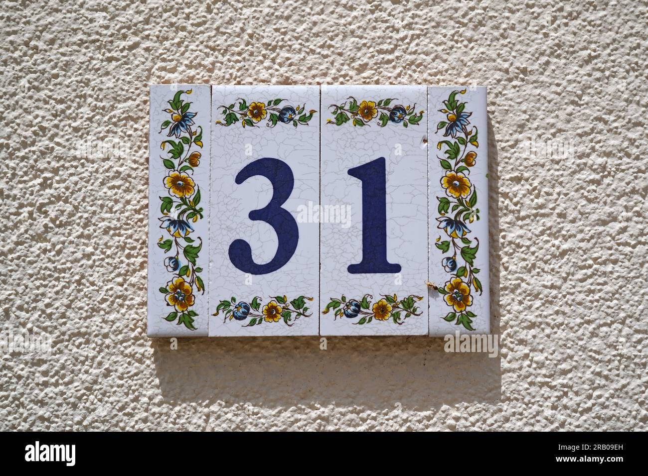 decorated ceramic tiles 31 house number on white rough wall Stock Photo ...