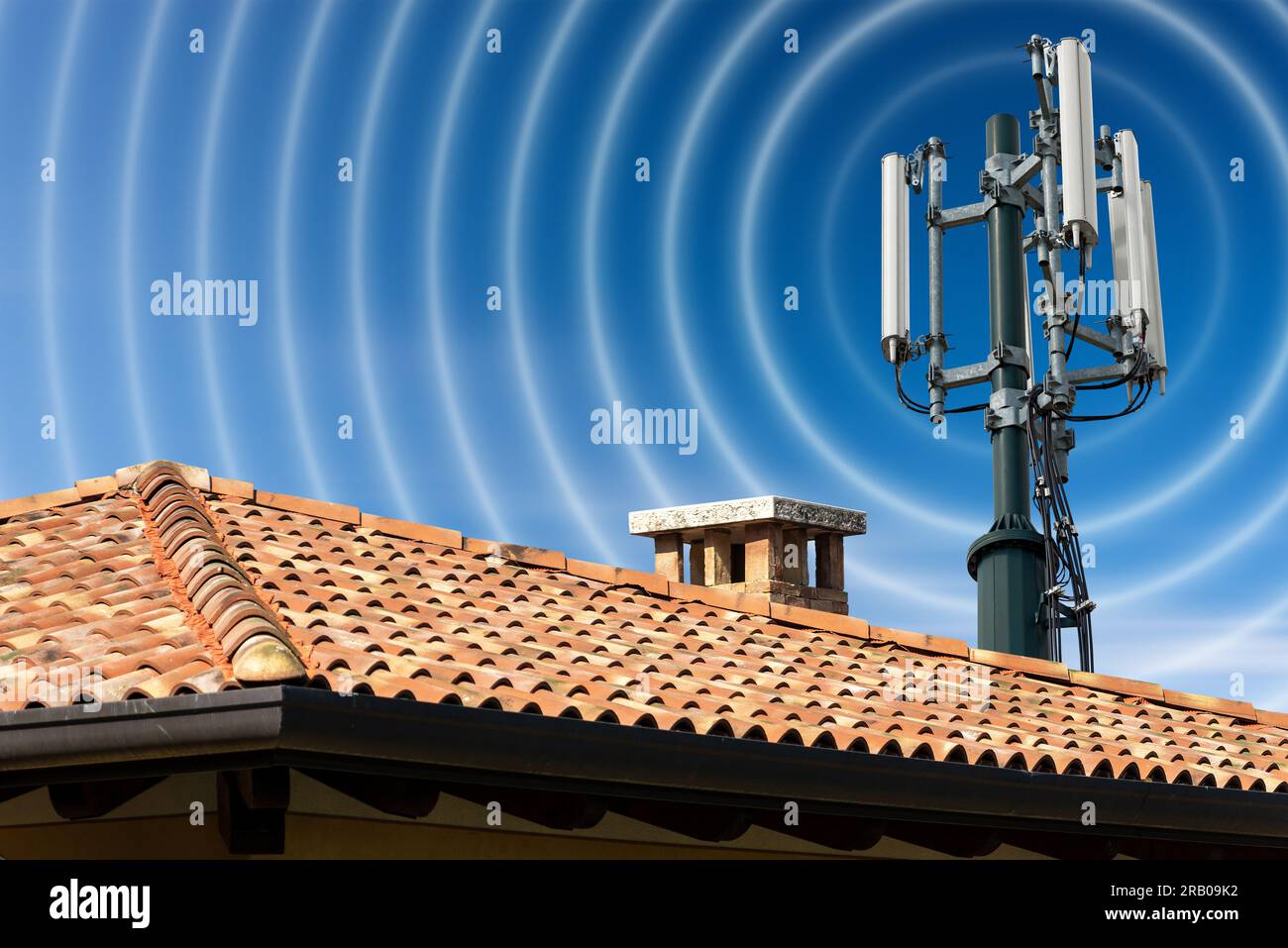 Closeup of a house roof with a telecommunications tower with antennas ...