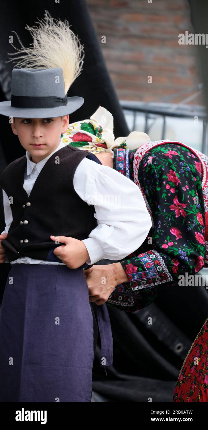 A boy in Traditional costume dancing at a cultural festival in ...
