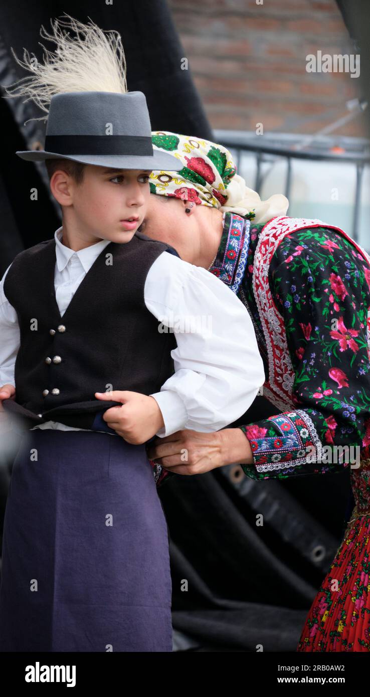 A boy in Traditional costume dancing at a cultural festival in ...