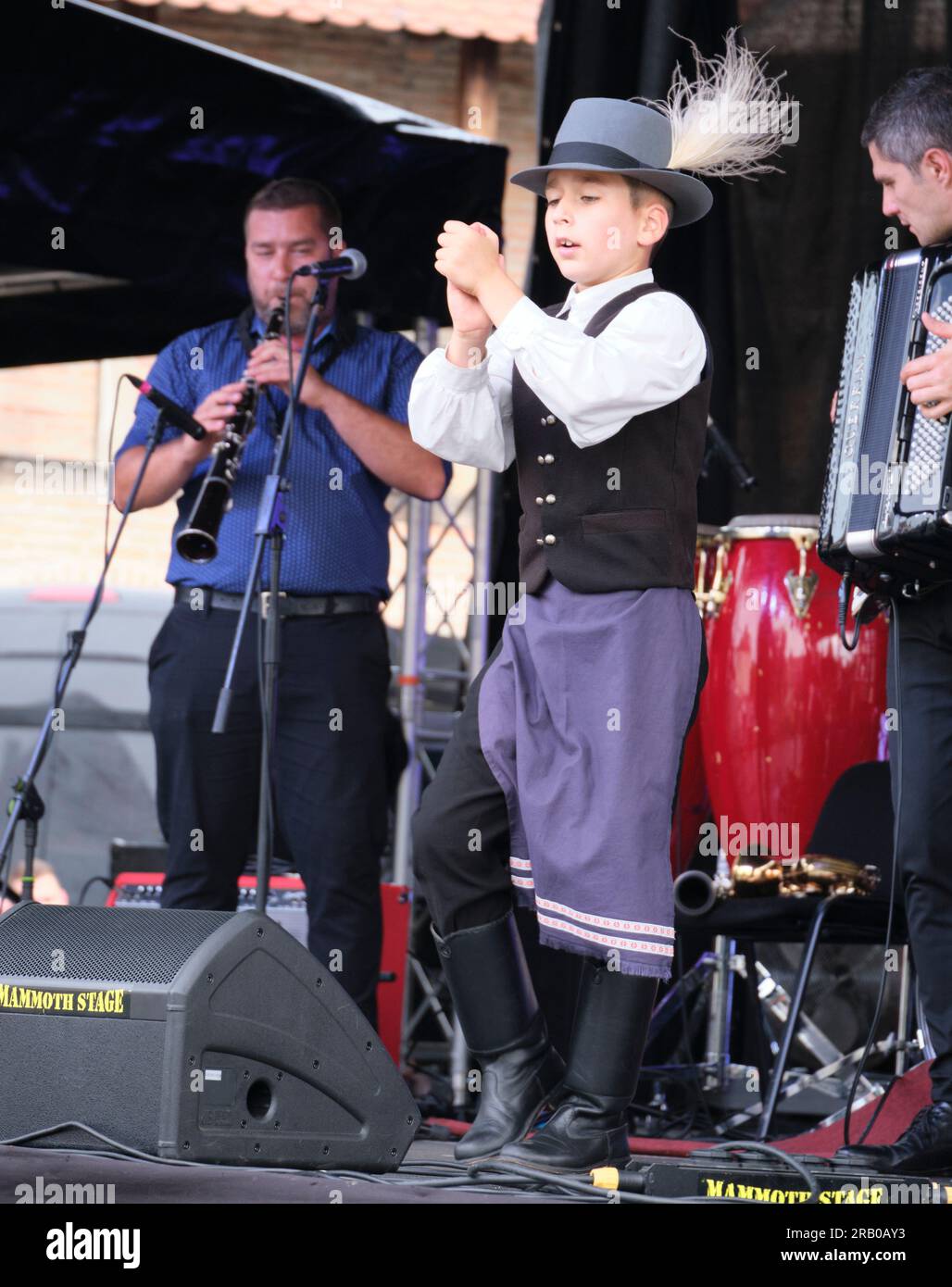 A boy in Traditional costume dancing at a cultural festival in ...