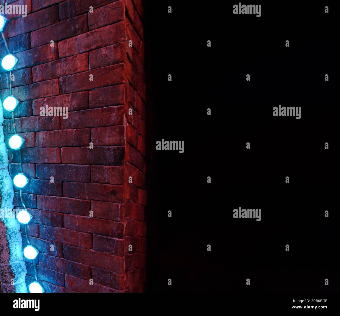 Blue light bulbs on brick wall with black background party celebration ...