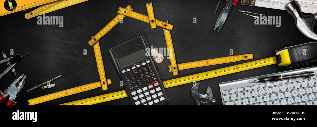 Folding wooden ruler in the shape of a house on a workbench with work ...
