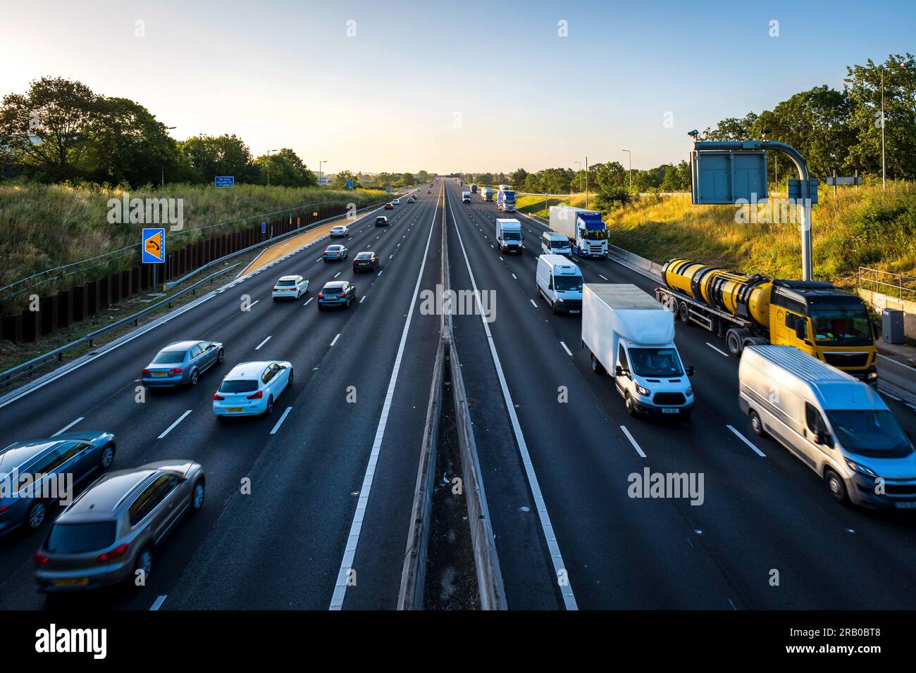 heavy traffic moving at speed on uk motorway in england at sunrise ...