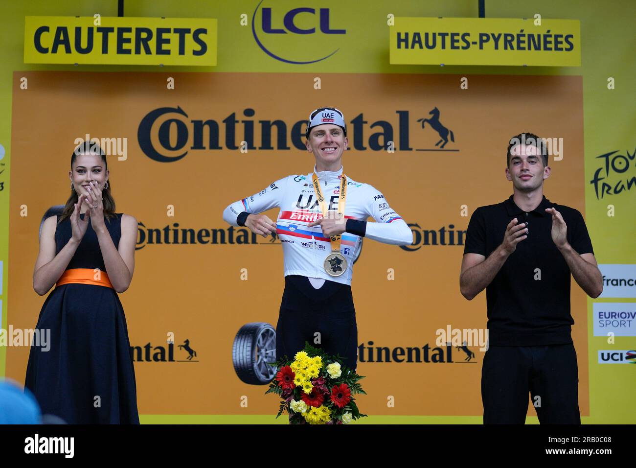 Slovenia's Tadej Pogacar celebrates on the podium after winning the ...