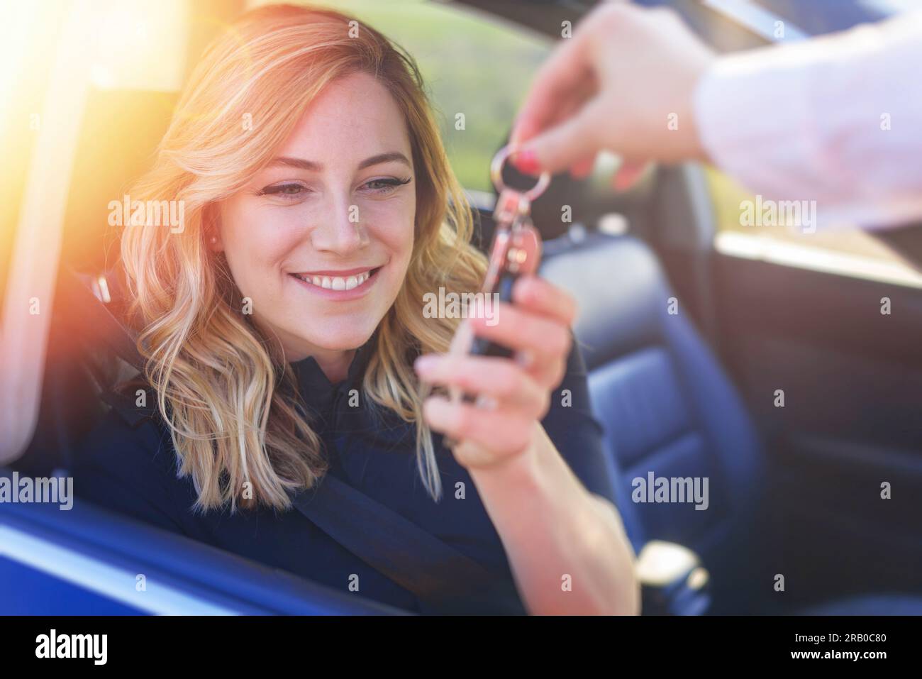 A woman's hand passes the key to the car Stock Photo - Alamy