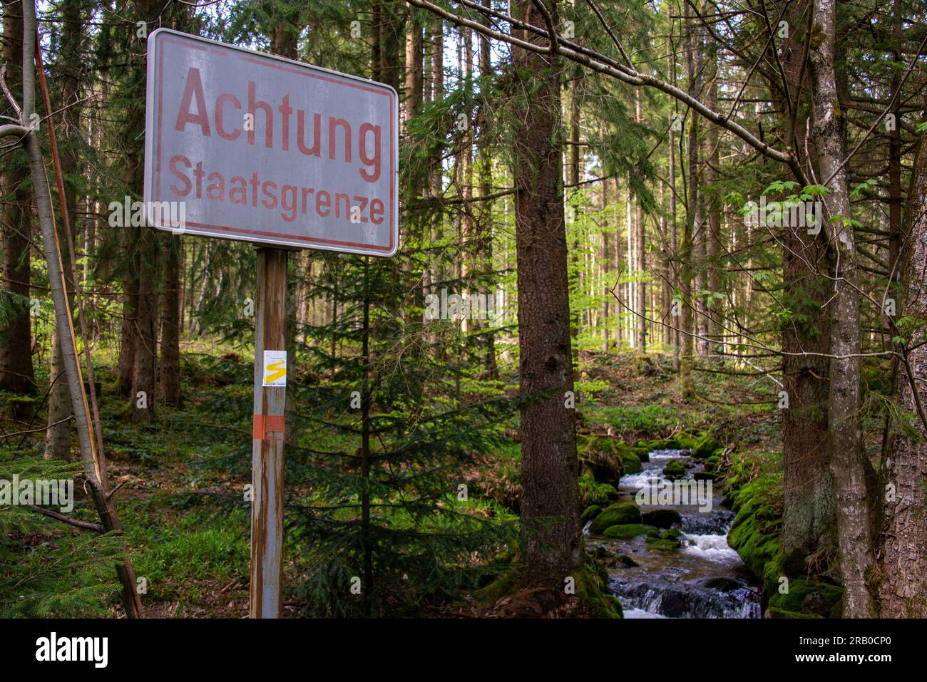 Attention! State Border! Sign on a hiking trail at the Austro-German ...