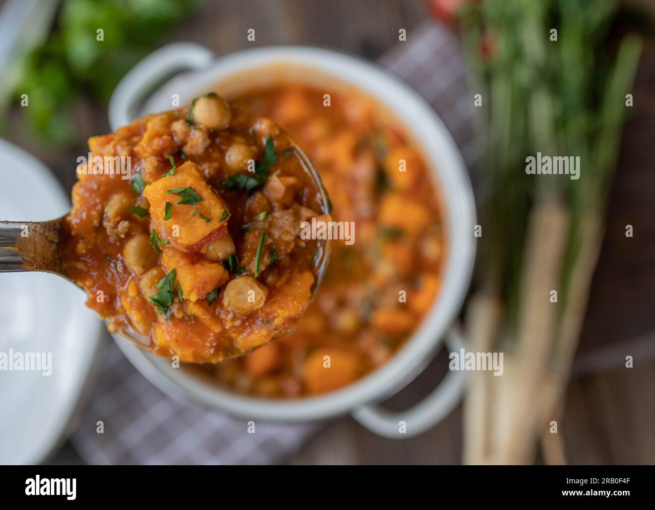 Chickpea stew with sweet potatoes and meat on a ladle Stock Photo - Alamy