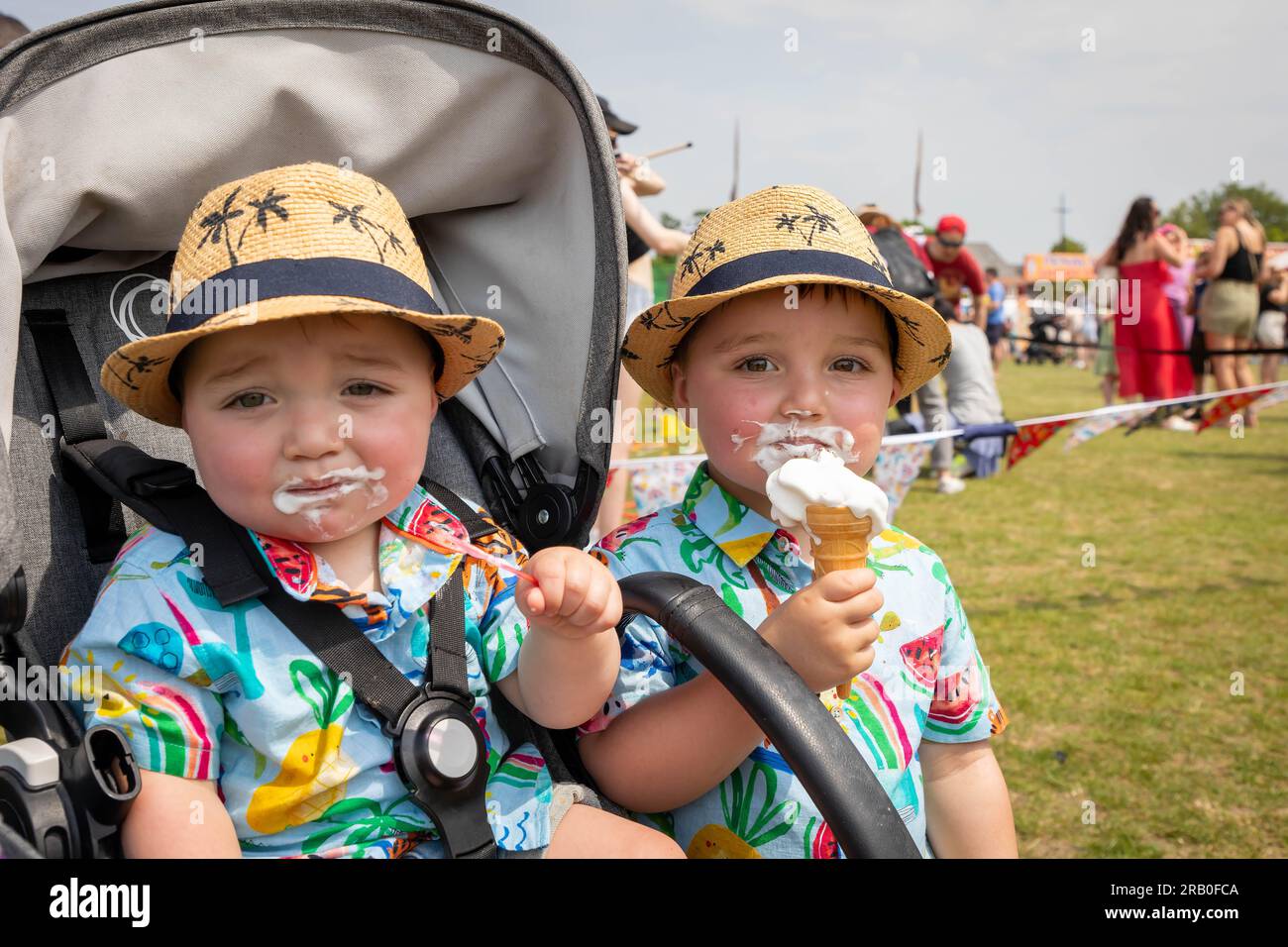 Brothers in matching clothes eating ice cream and making a mess around ...