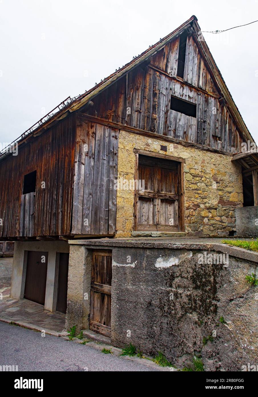 An old and now disused farming building in village of Ovaro in Udine ...