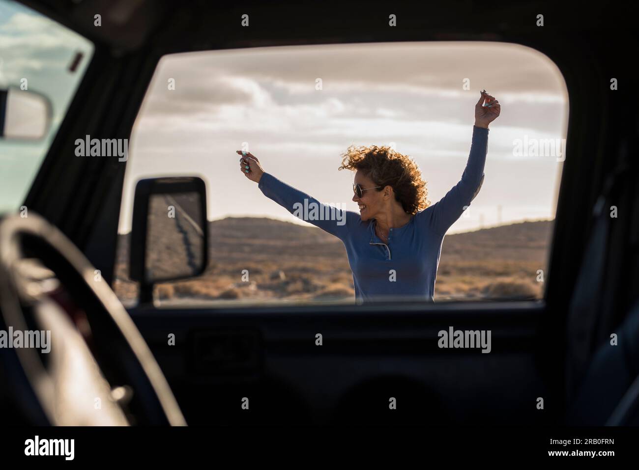 Excited happy female traveler jumping crazy having fun at arrival ...