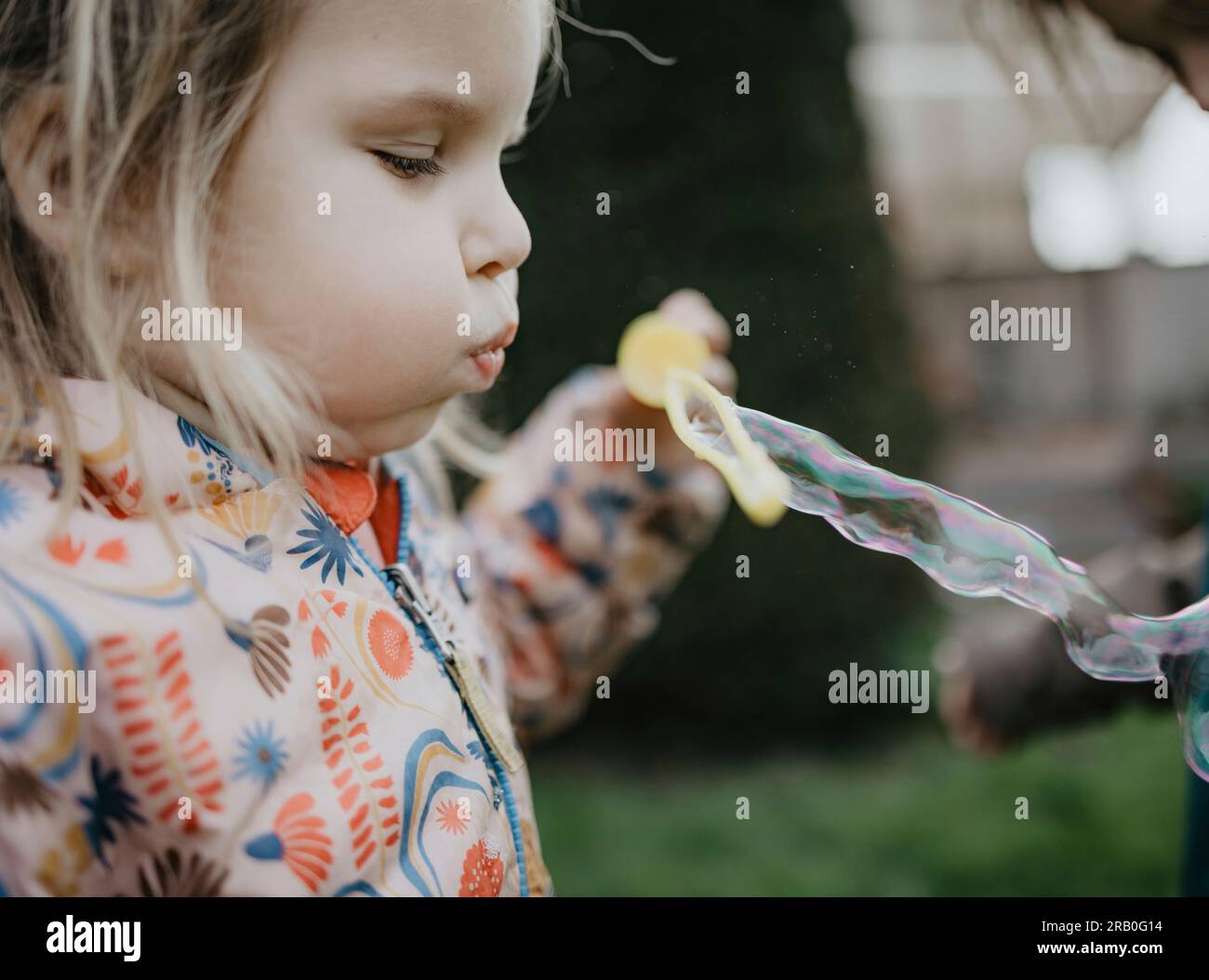 Little girl making bubbles Stock Photo - Alamy