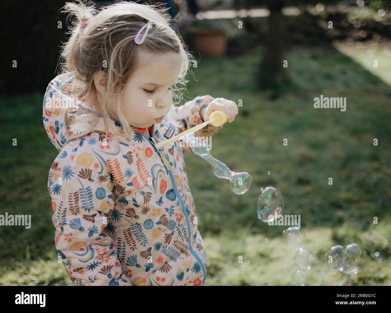 Little girl making bubbles Stock Photo - Alamy