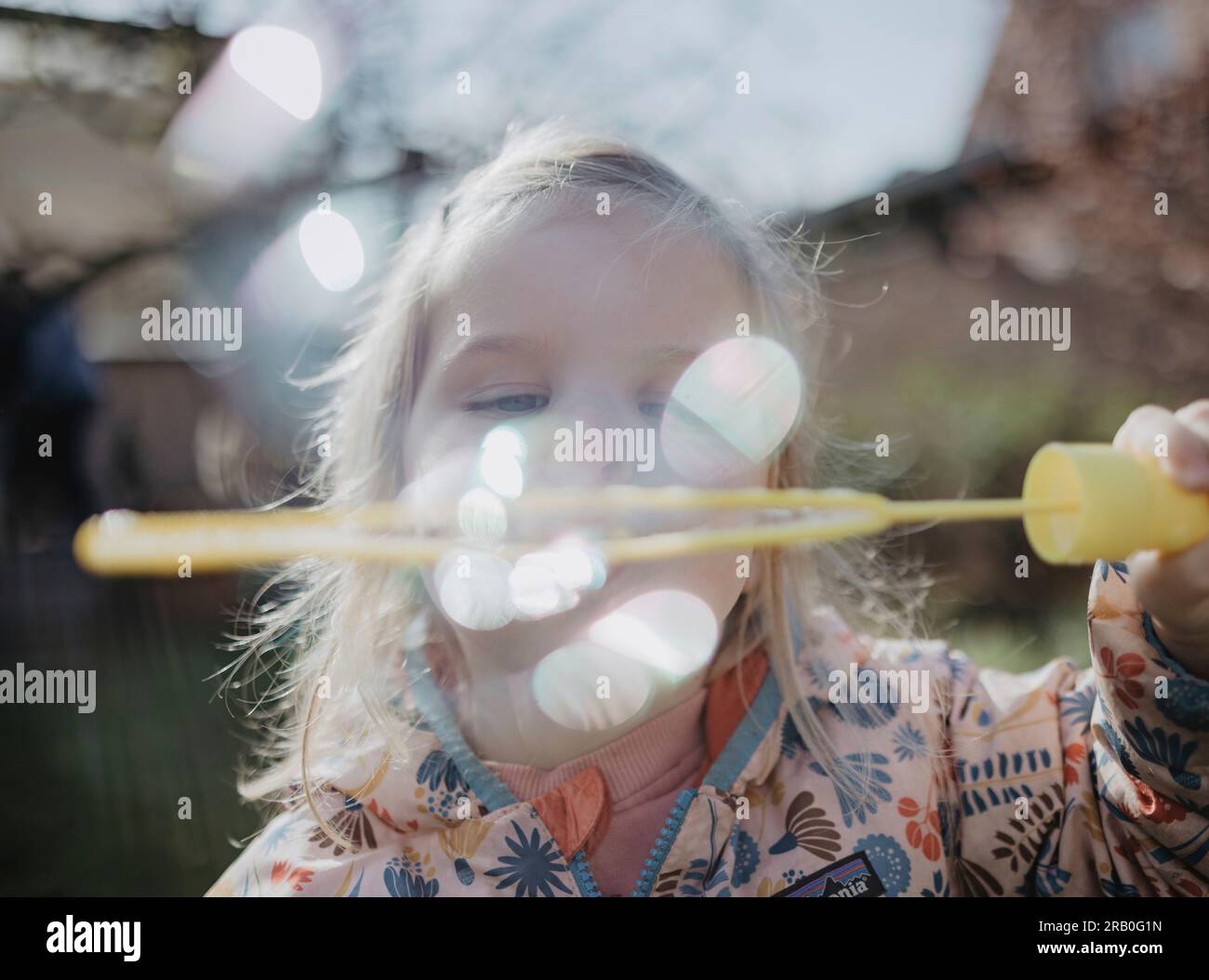 Little girl making bubbles Stock Photo - Alamy