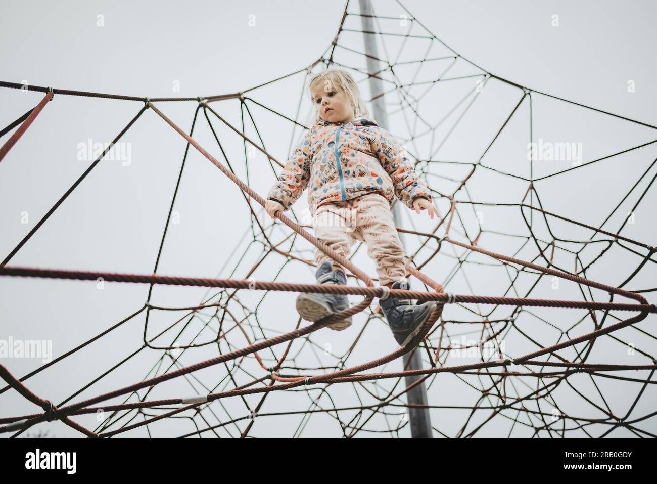 Little girl on climbing frame Stock Photo - Alamy