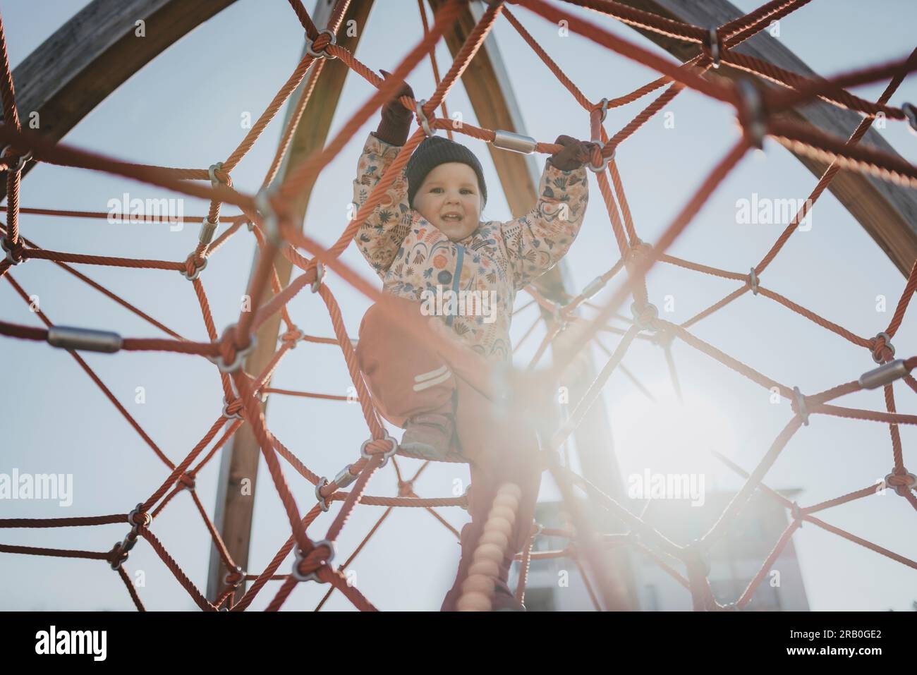 Little girl on climbing frame Stock Photo - Alamy