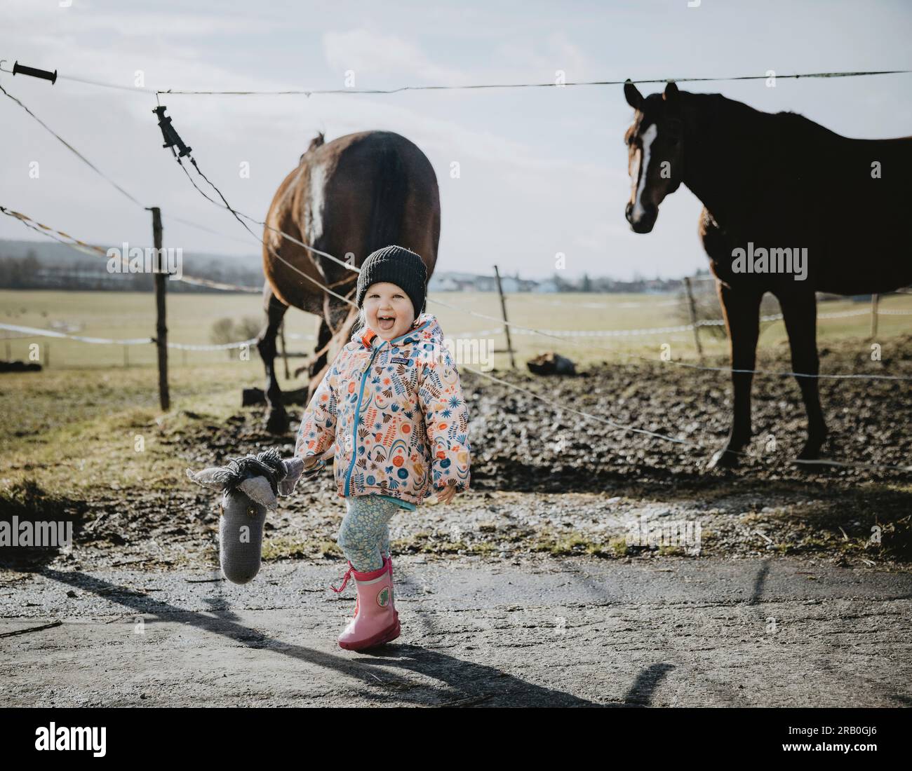 Little girl riding with her hobby horse hi-res stock photography and ...