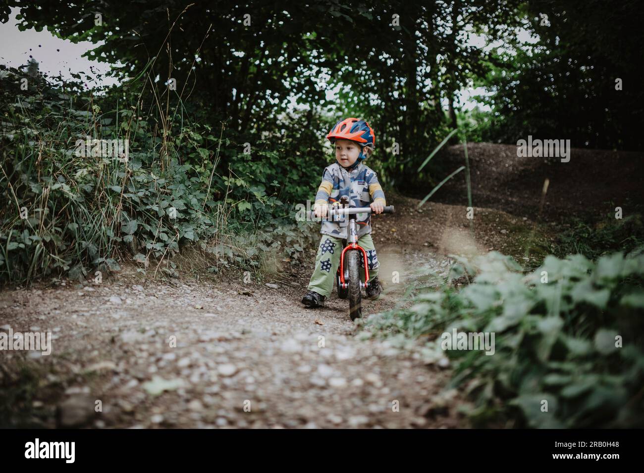 Little boy with running wheel Stock Photo - Alamy