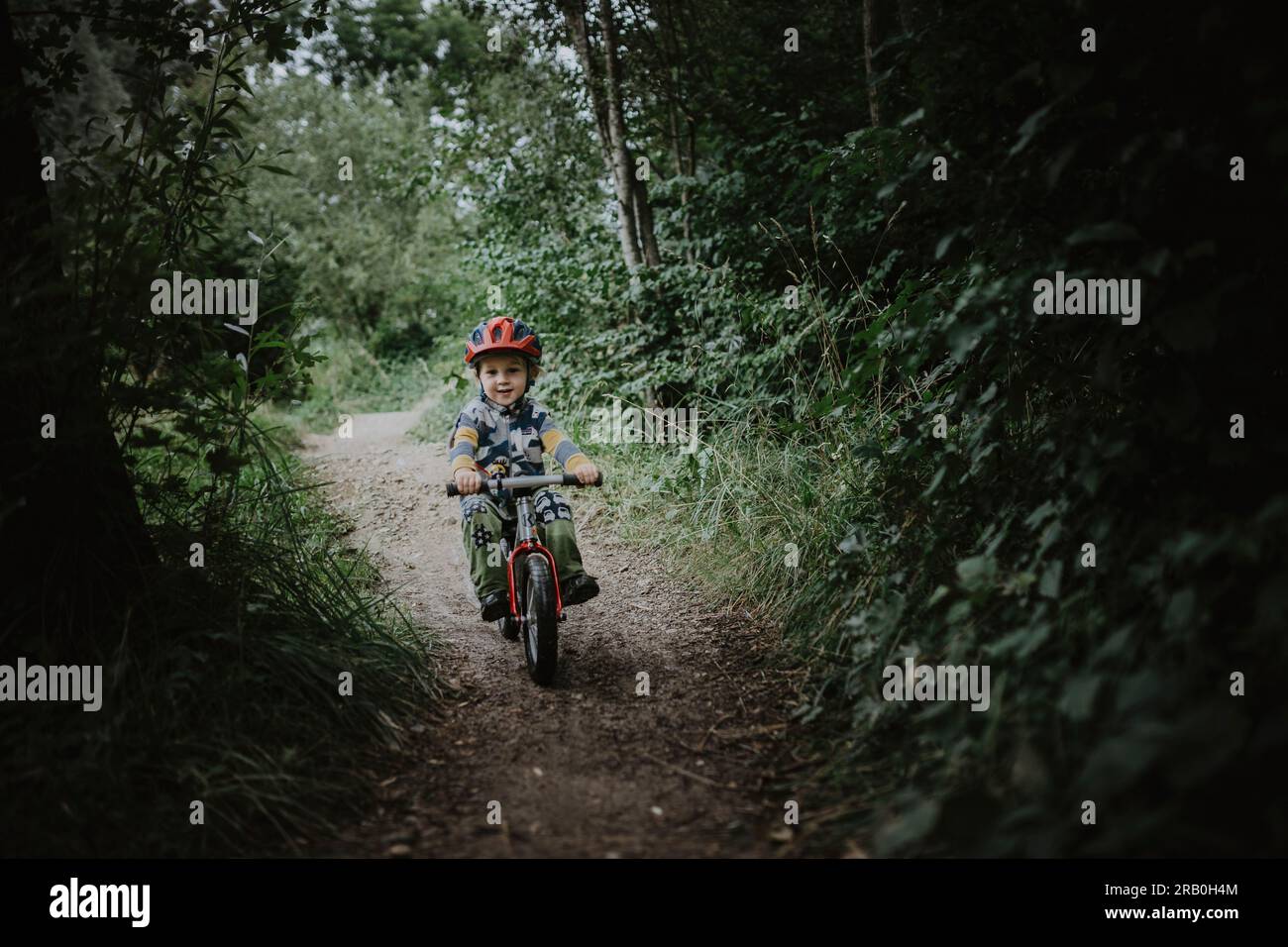 Little boy with running wheel Stock Photo - Alamy
