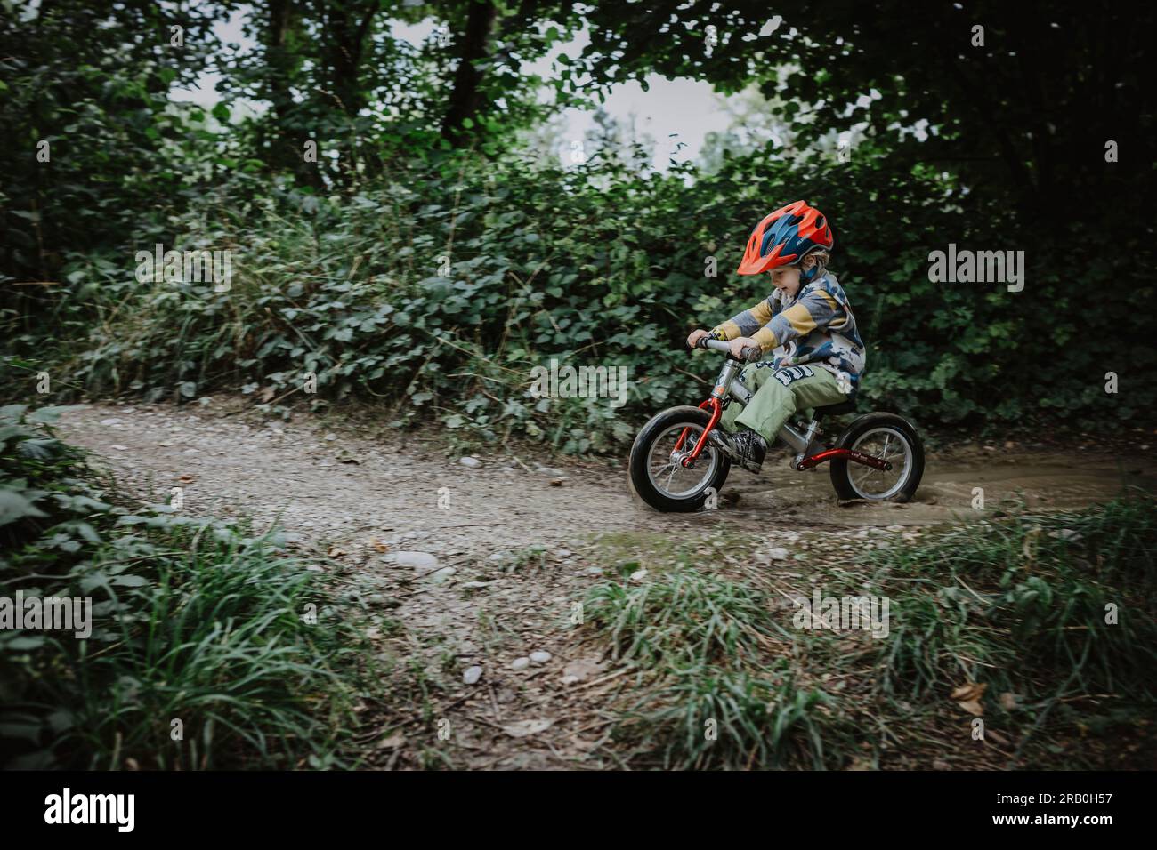 Little boy with running wheel Stock Photo - Alamy