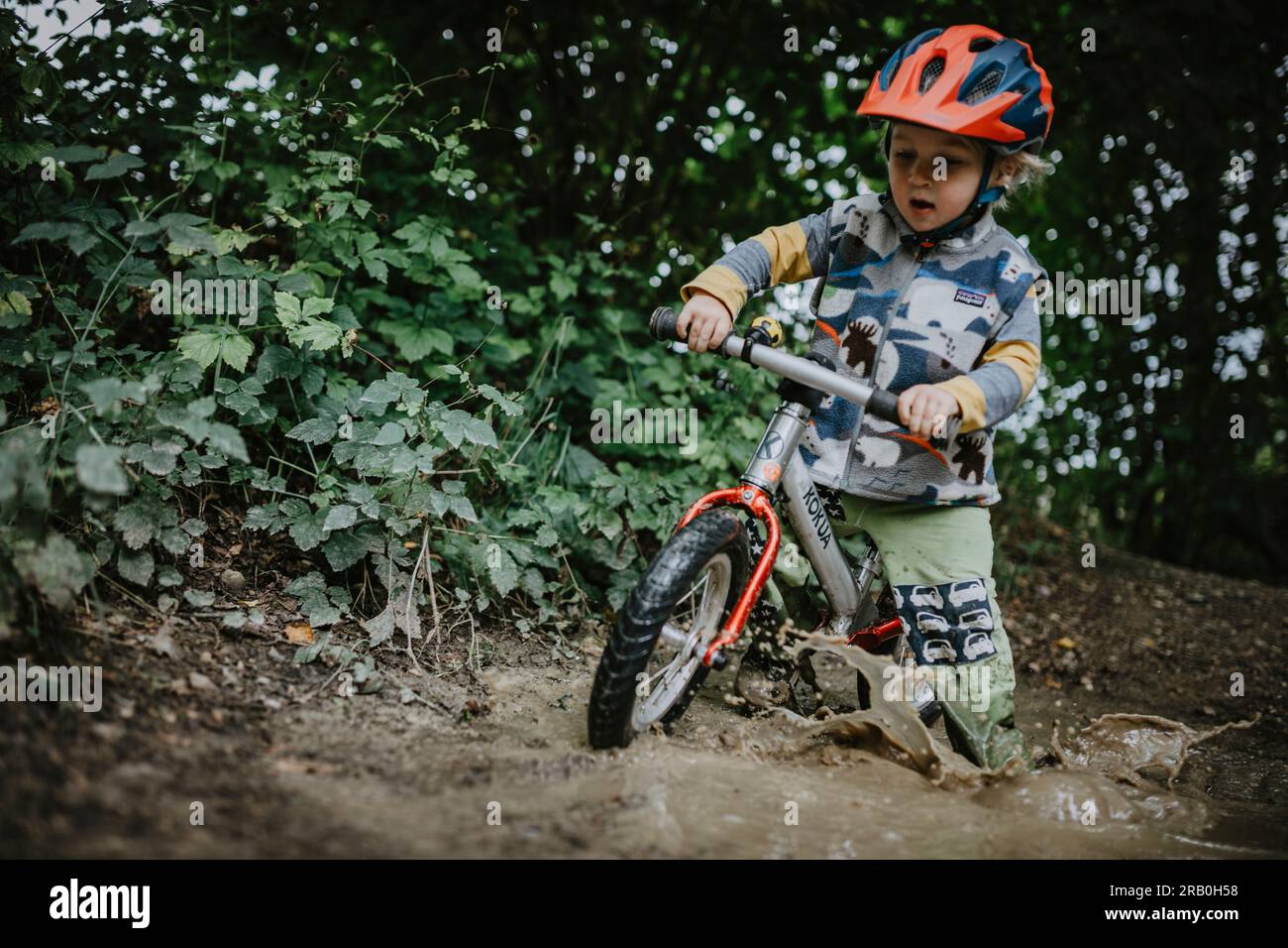 Little boy with running wheel Stock Photo - Alamy