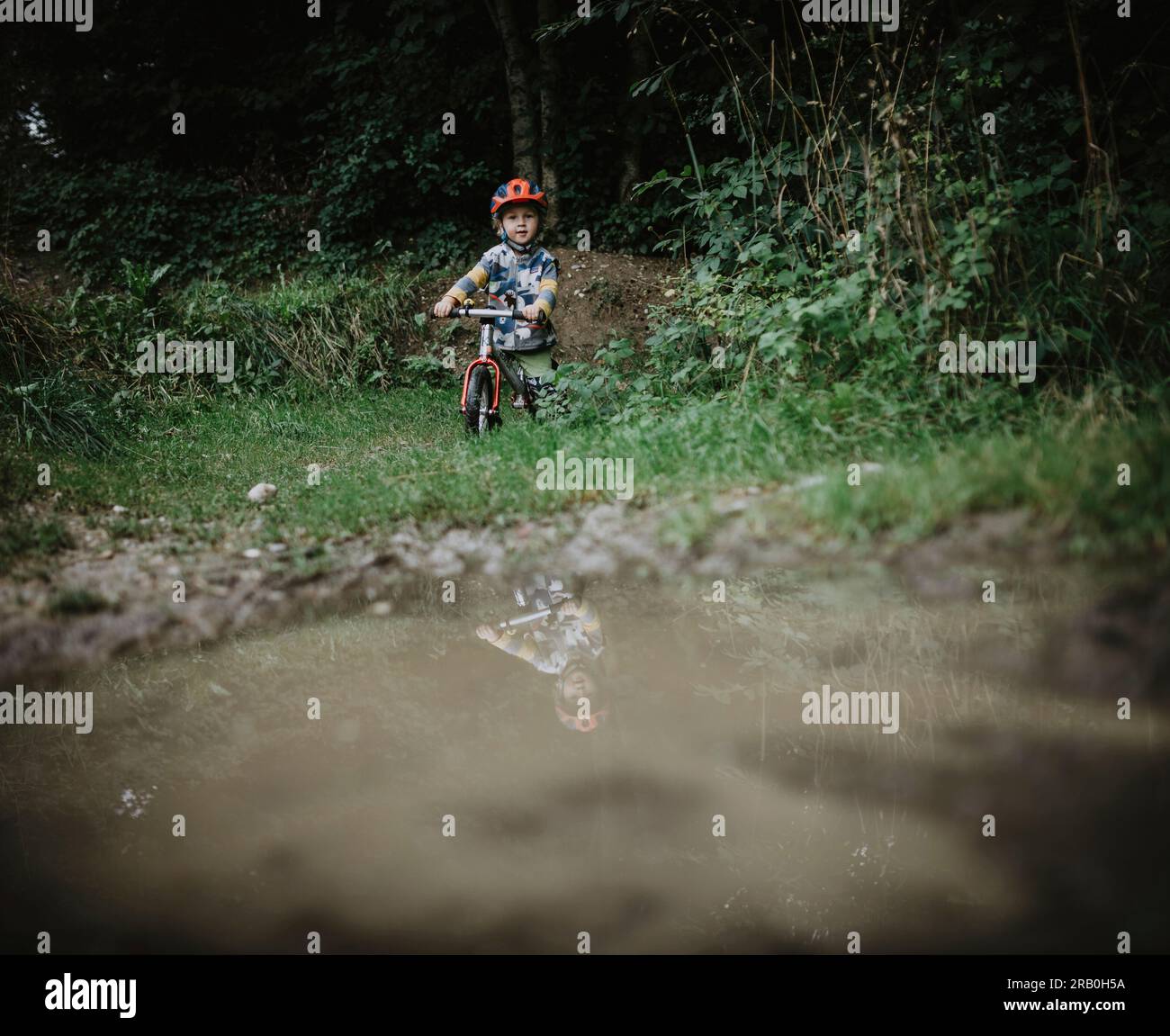 Little boy with running wheel Stock Photo - Alamy