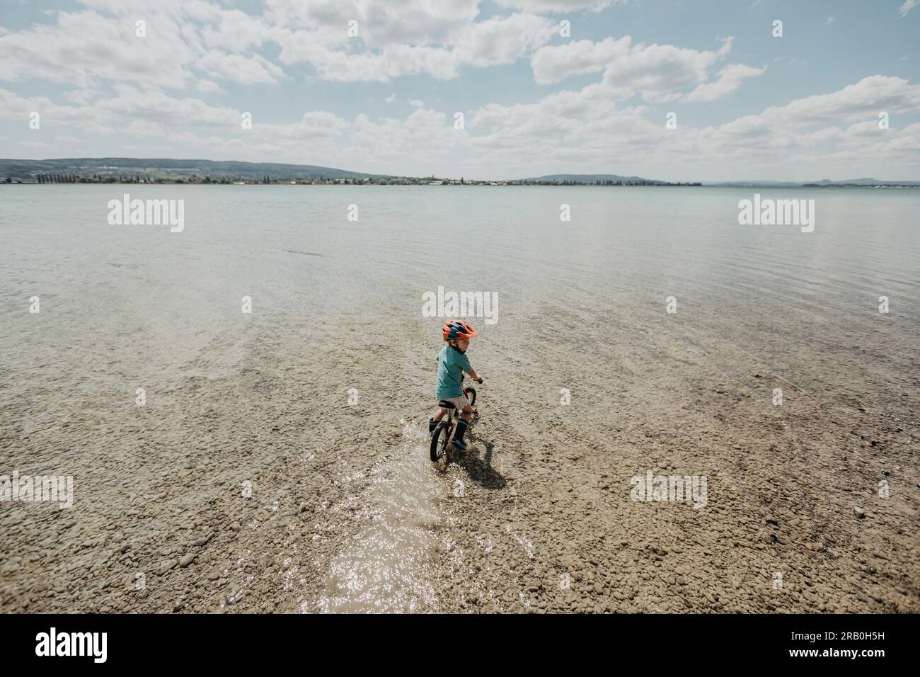 Little boy with running wheel Stock Photo - Alamy