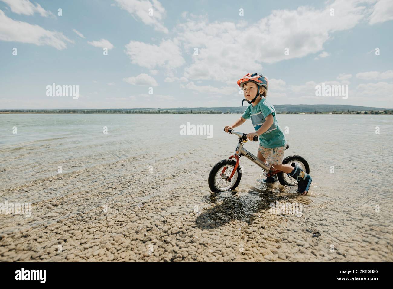 Little boy with running wheel Stock Photo - Alamy