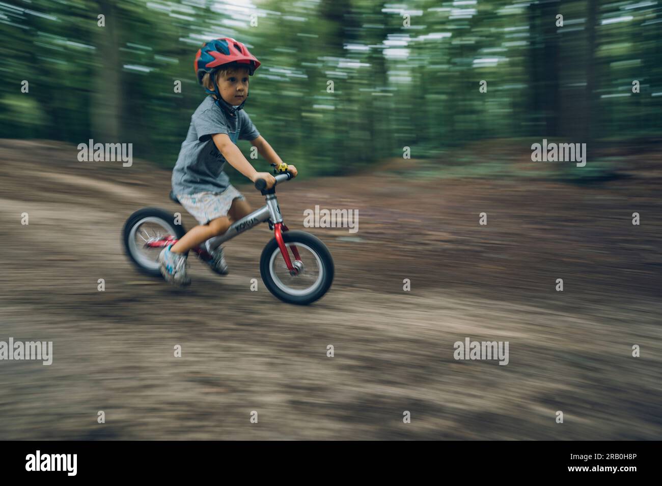 Little boy with running wheel Stock Photo - Alamy