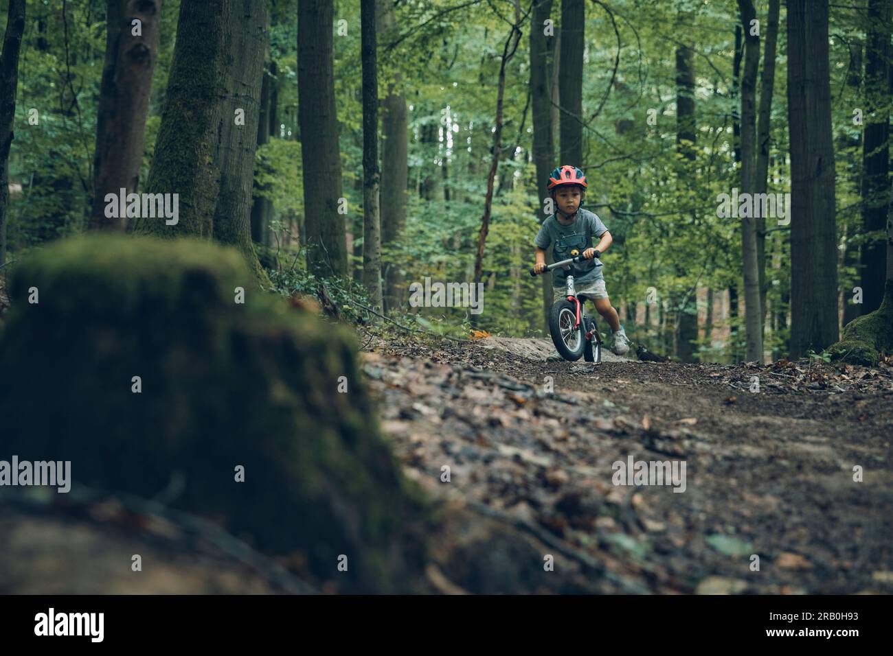 Little boy with running wheel Stock Photo - Alamy