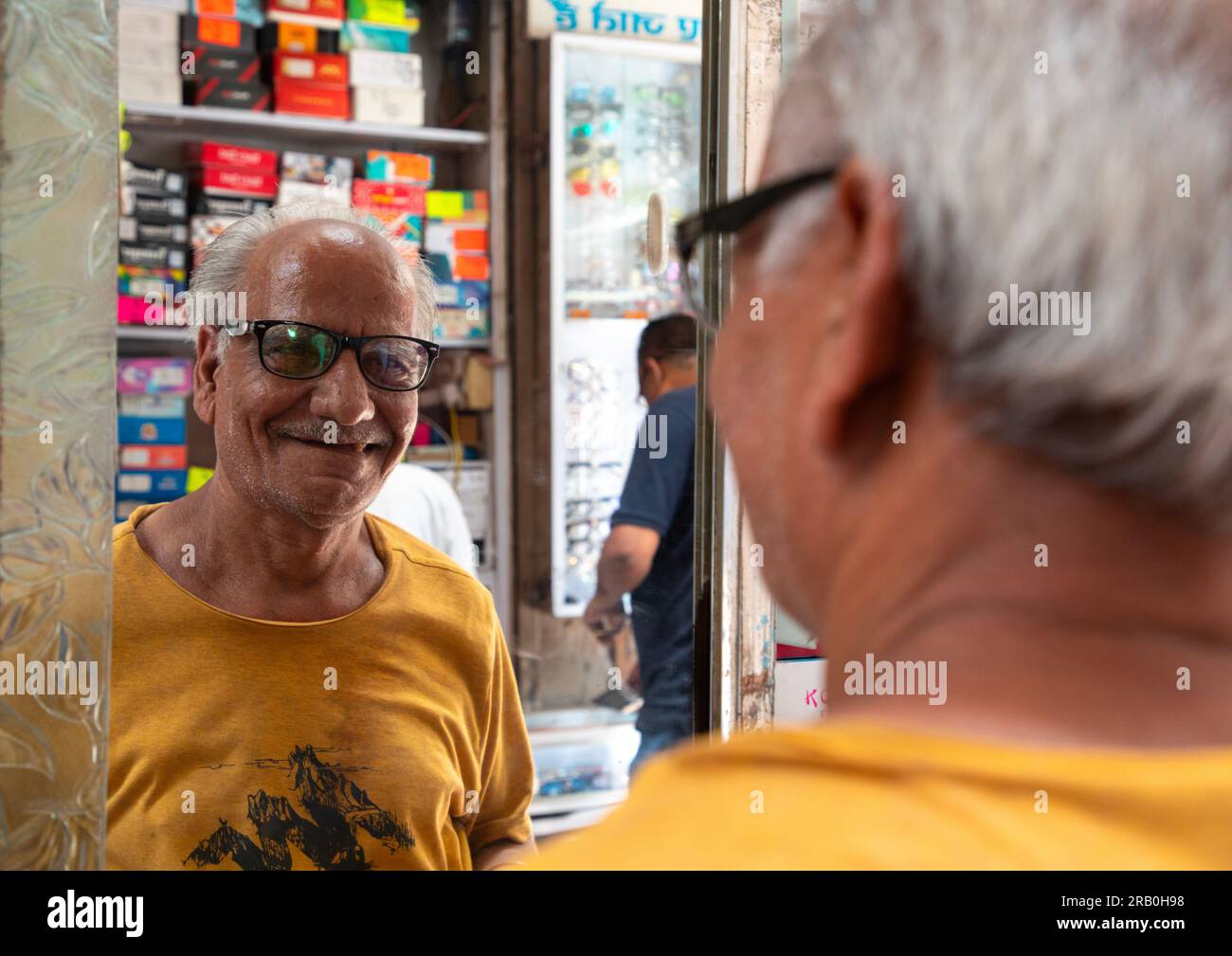 Smiling indian man choosing eyeglasses in an optics, Delhi, New Delhi ...
