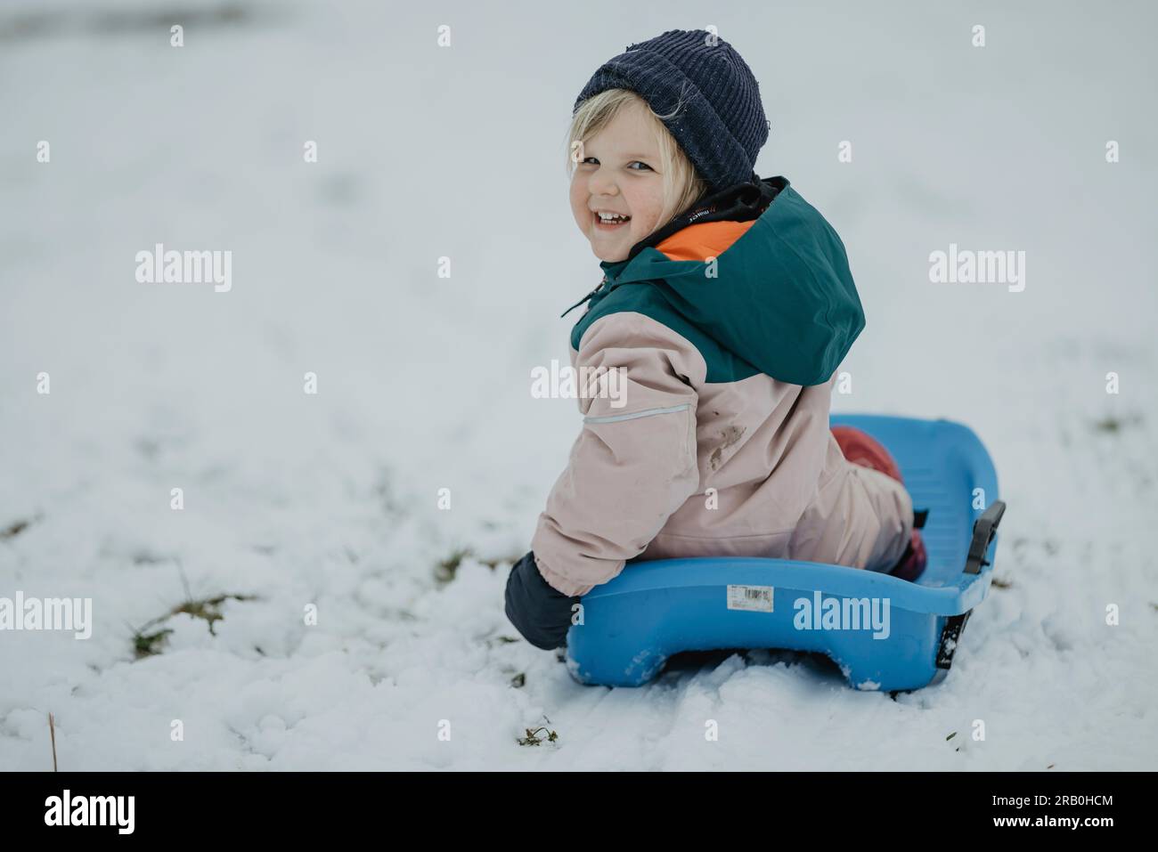 Little girl sledding Stock Photo - Alamy