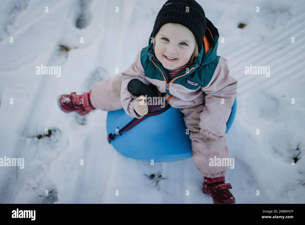 Little girl sledding Stock Photo - Alamy