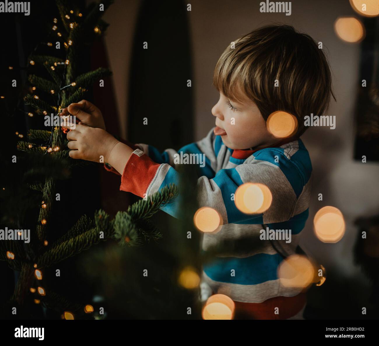 Boy by the christmas tree hi-res stock photography and images - Alamy