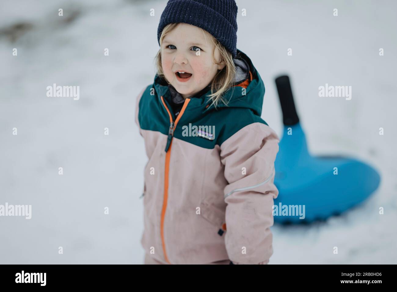 Little girl sledding Stock Photo - Alamy