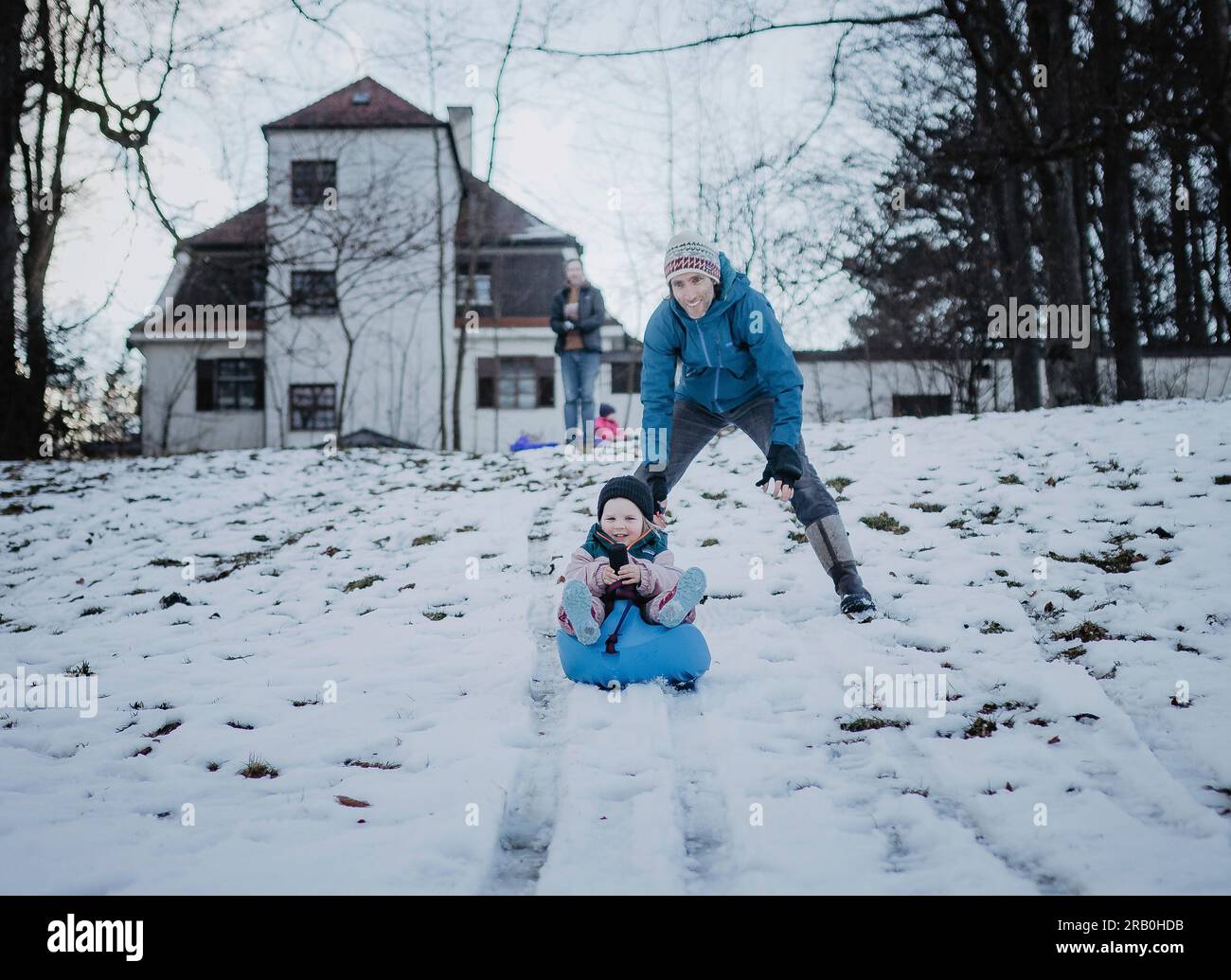 Little girl sledding Stock Photo - Alamy