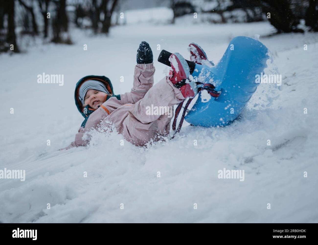 Little girl sledding Stock Photo - Alamy