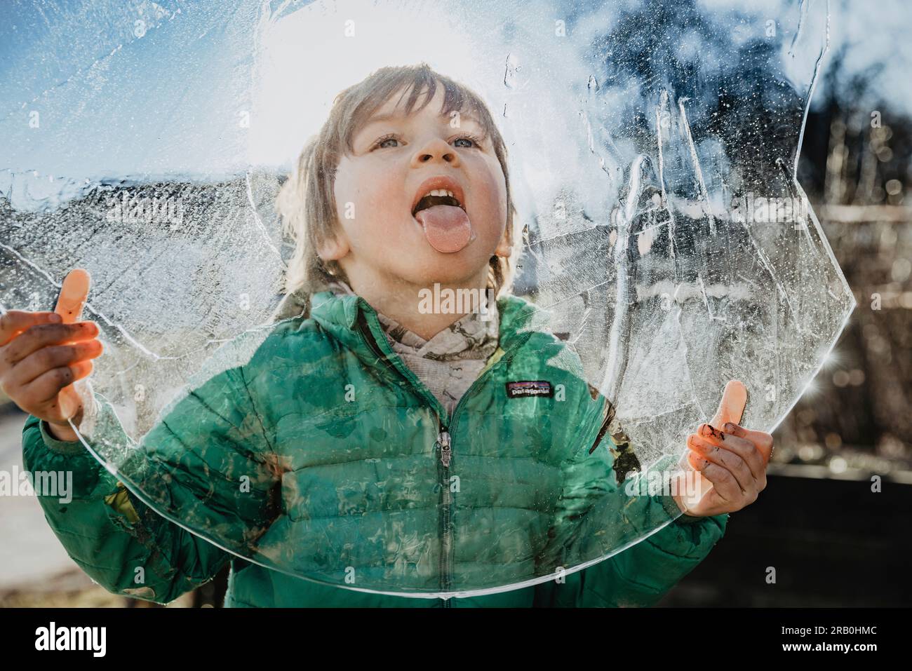 Little boy playing with a block of ice Stock Photo - Alamy