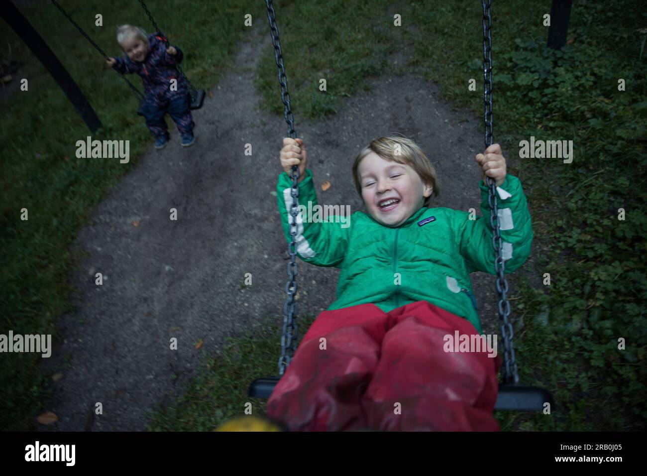 Boy on a swing Stock Photo - Alamy