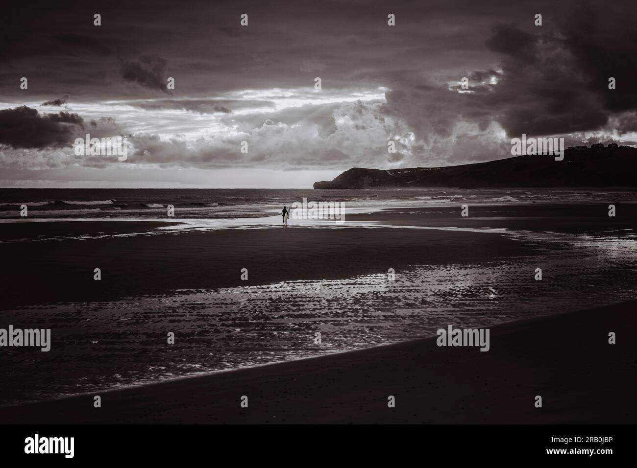 Surfer on beach Stock Photo - Alamy