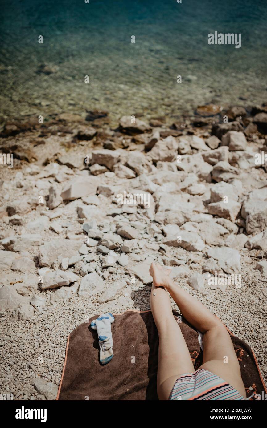 Woman lay on the beach hi-res stock photography and images - Alamy