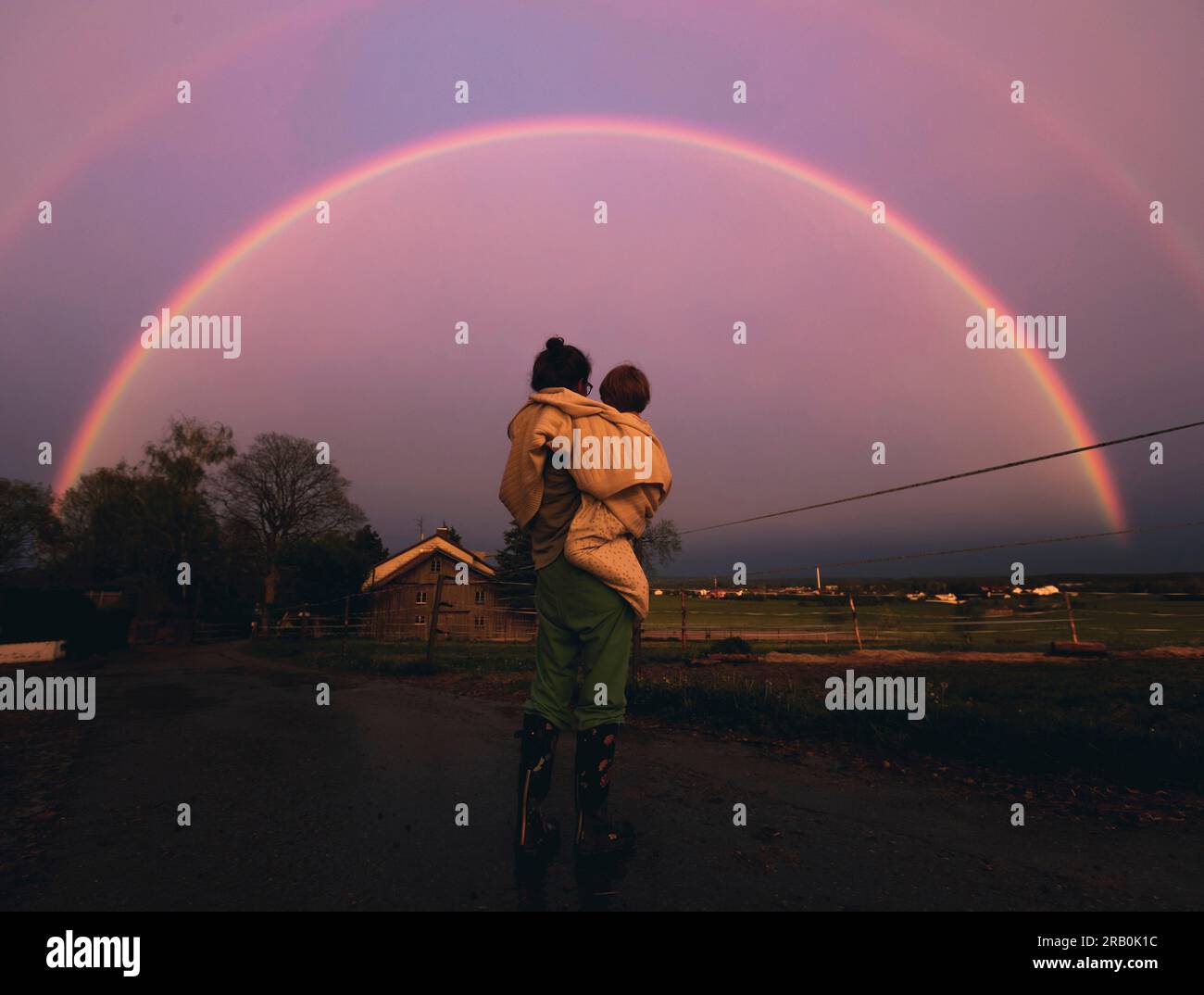 Mother and son look at double rainbow Stock Photo - Alamy