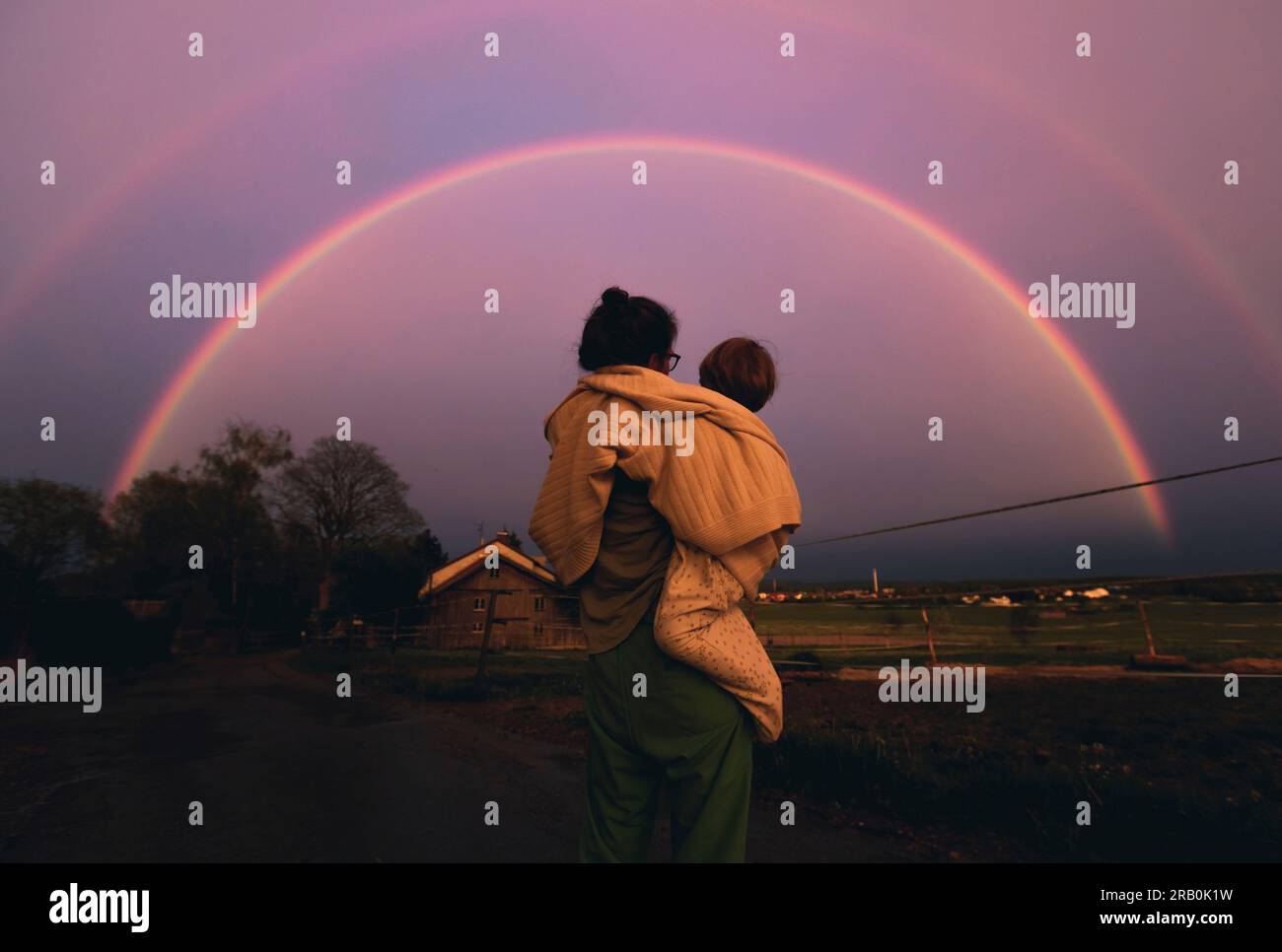 Mother and son look at double rainbow Stock Photo - Alamy