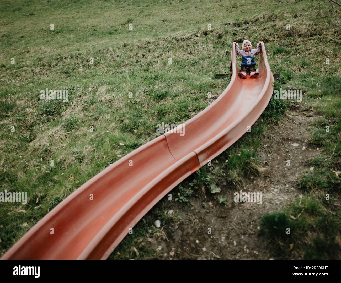 Little girl on the slide Stock Photo - Alamy