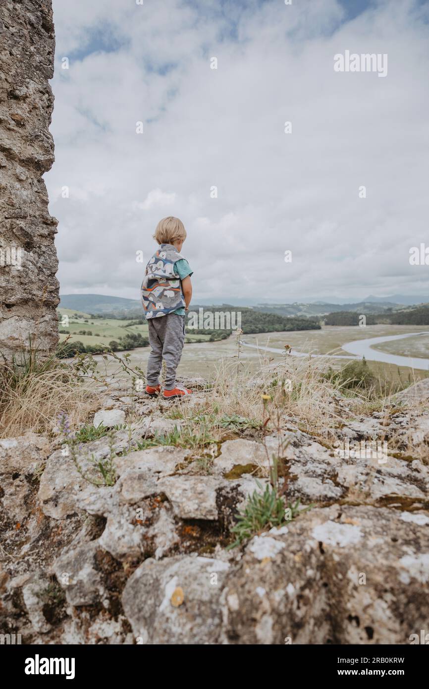 Boy in a castle ruin Stock Photo - Alamy