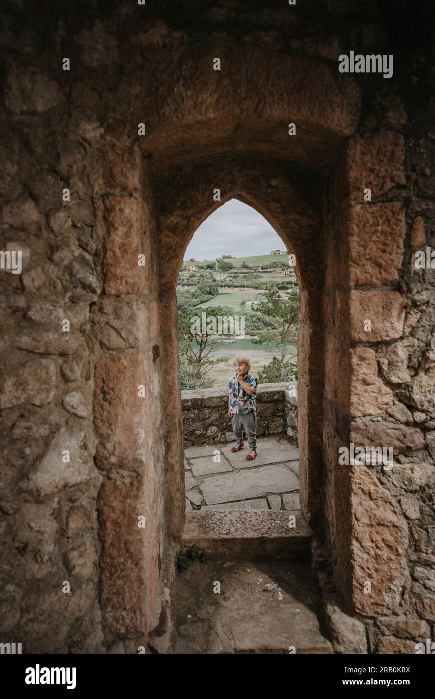 Boy in a castle ruin Stock Photo - Alamy