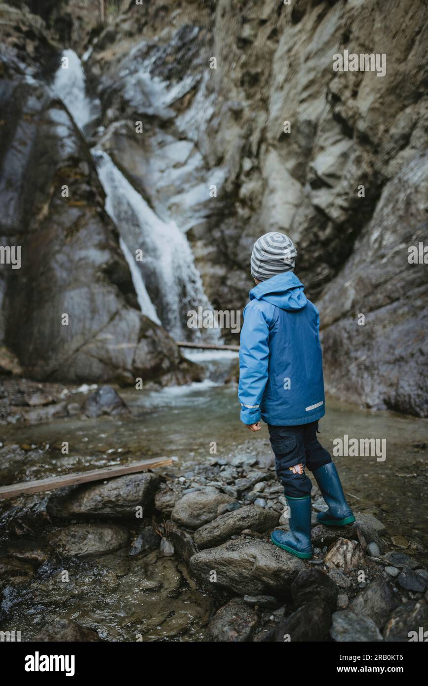Boy at a waterfall Stock Photo - Alamy