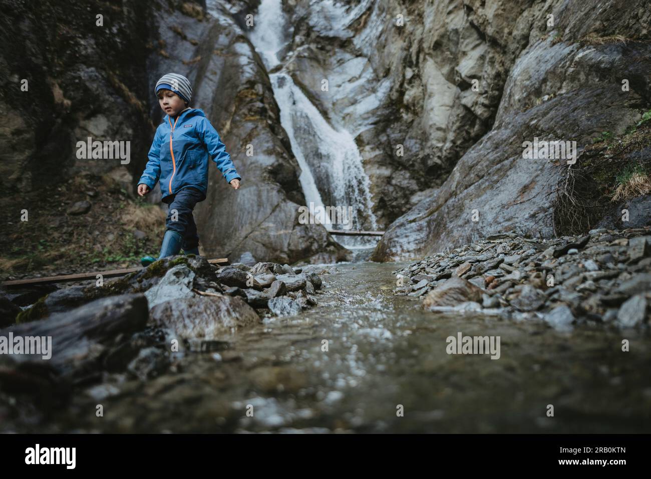 Boy at a waterfall Stock Photo - Alamy