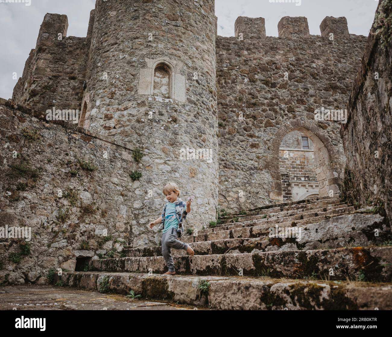 Boy in a castle ruin Stock Photo - Alamy